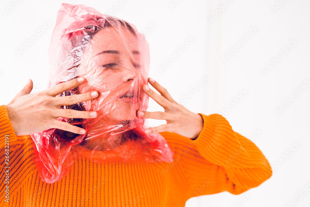 Young woman with plastic bag on her head choking, antipollution save ...