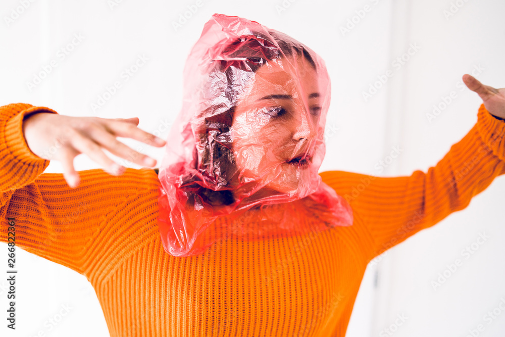 Young woman with plastic bag on her head choking, antipollution save ...