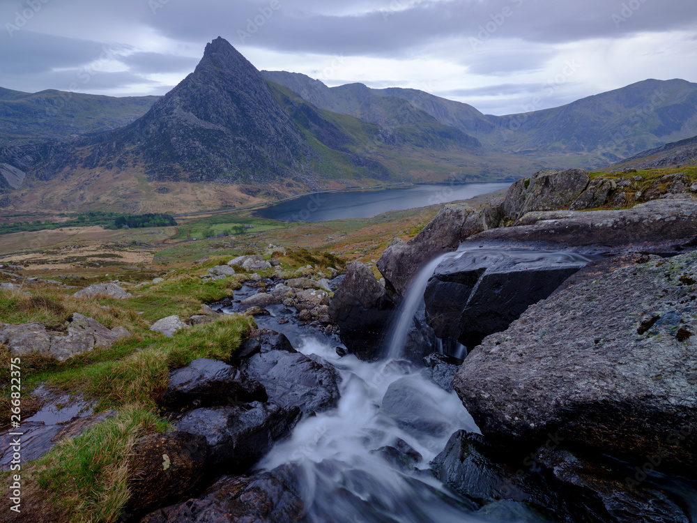Tryfan in spring with the Afon Lloer in flow over the waterfalls, Wales ...