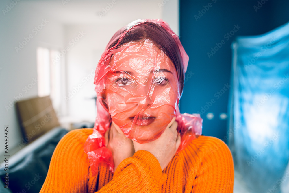 Foto de Young woman with plastic bag on her head choking, antipollution ...