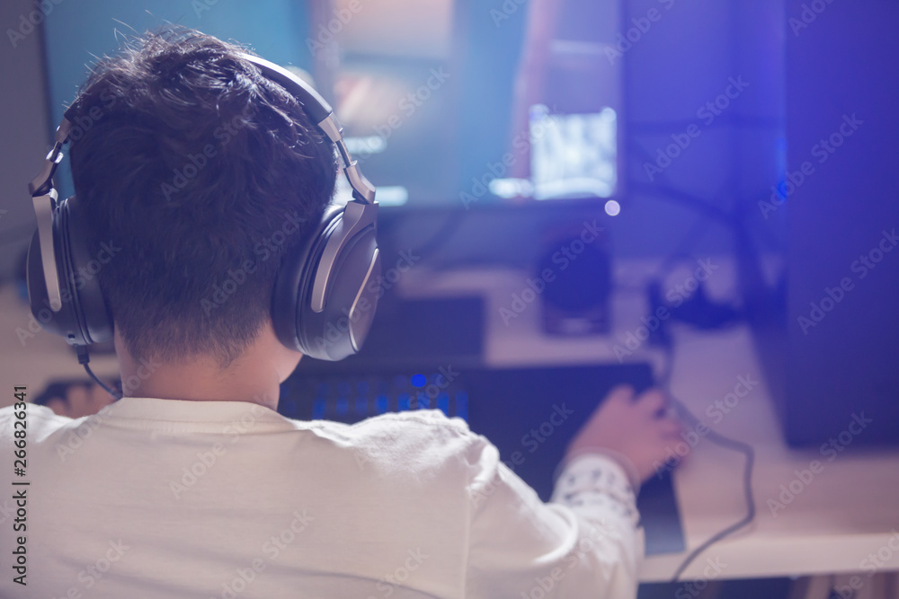 Portrait of asian boy gamer playing games on computer in the room at ...