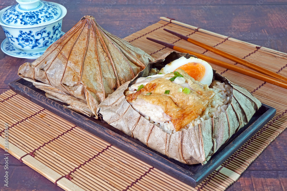 Rice wrapped in lotus leaf. Roasted chicken, boiled egg, vegetables and ...