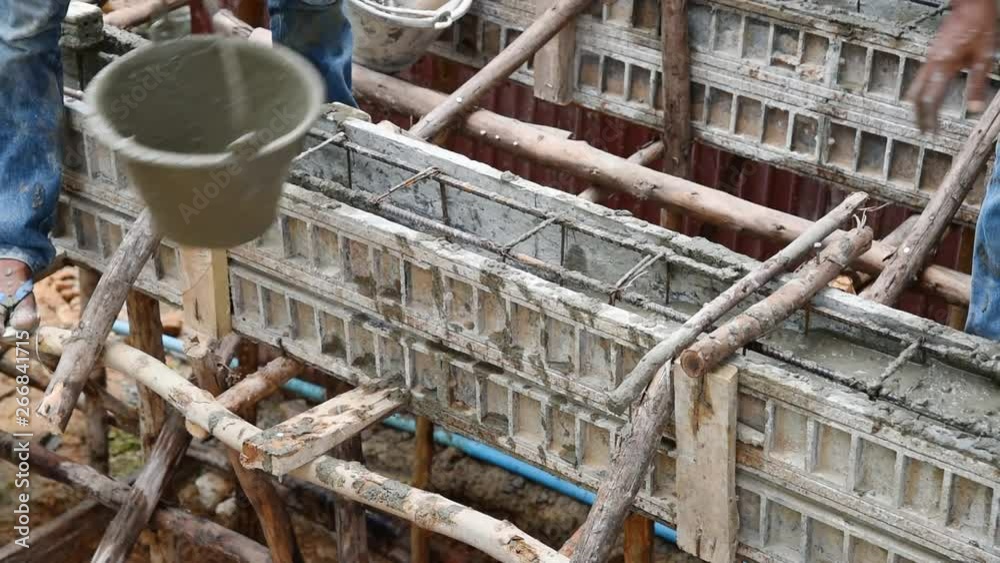 Worker pouring cement in to the structure. The cement tank is pouring ...