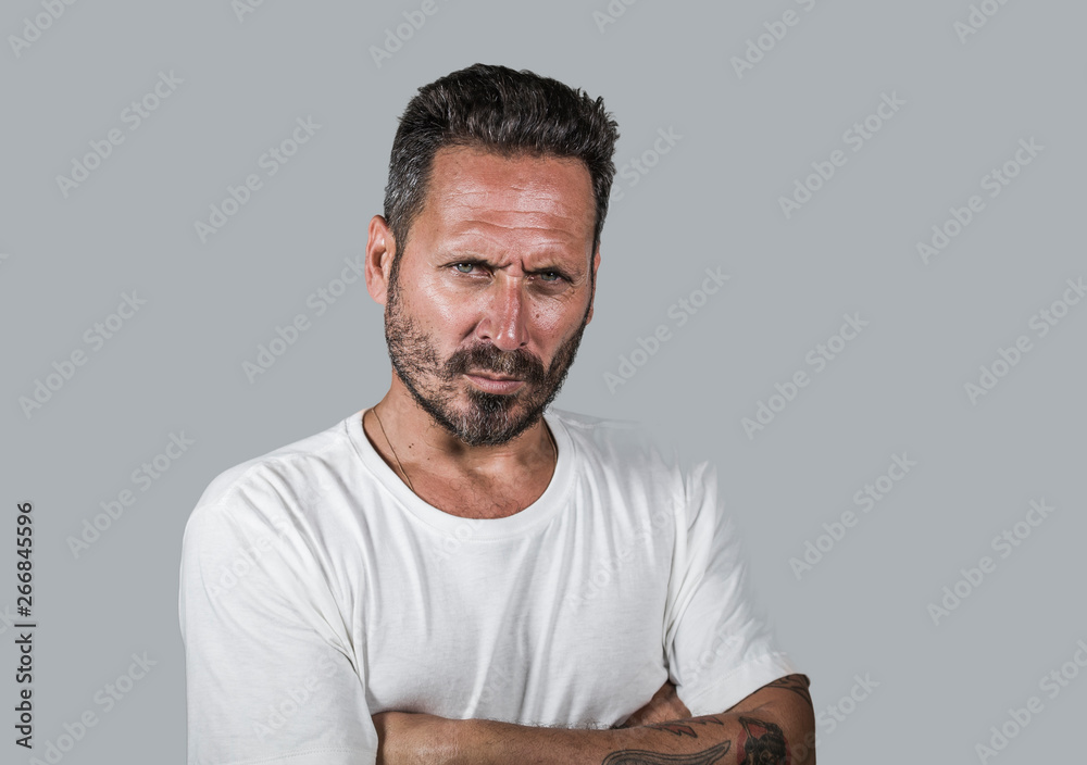 handsome and attractive man with beard looking with intense eyes ...