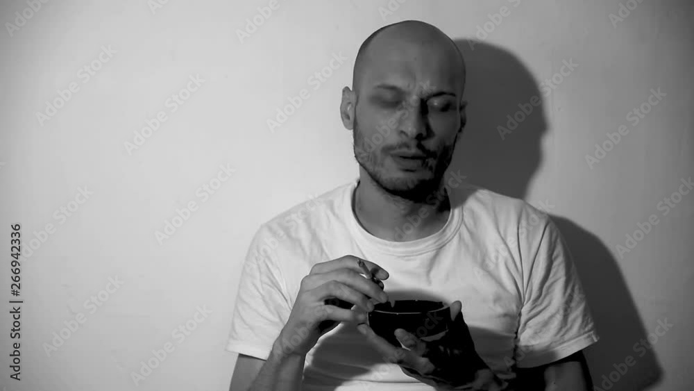 Vídeo do Stock: Young nervous smoker man smoking cigarette in cloud of ...