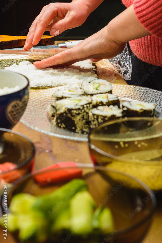 The process of preparing sushi from rice and additional ingredients at ...
