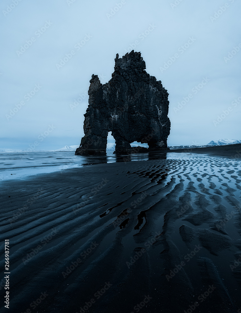 Picturesque view of pebble beach of seashore with rocks in water under ...