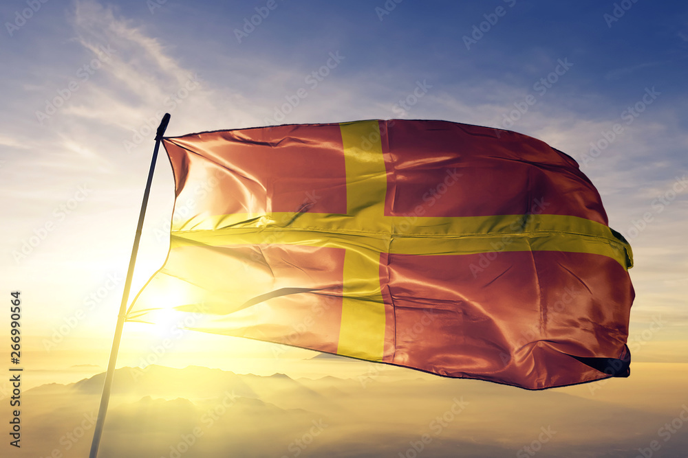 Skaneland Scania flag waving on the top sunrise mist fog Stock Photo ...
