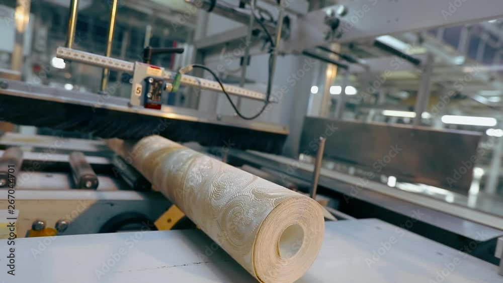 Production of wallpaper, a roll of wallpaper on a conveyor line, the ...