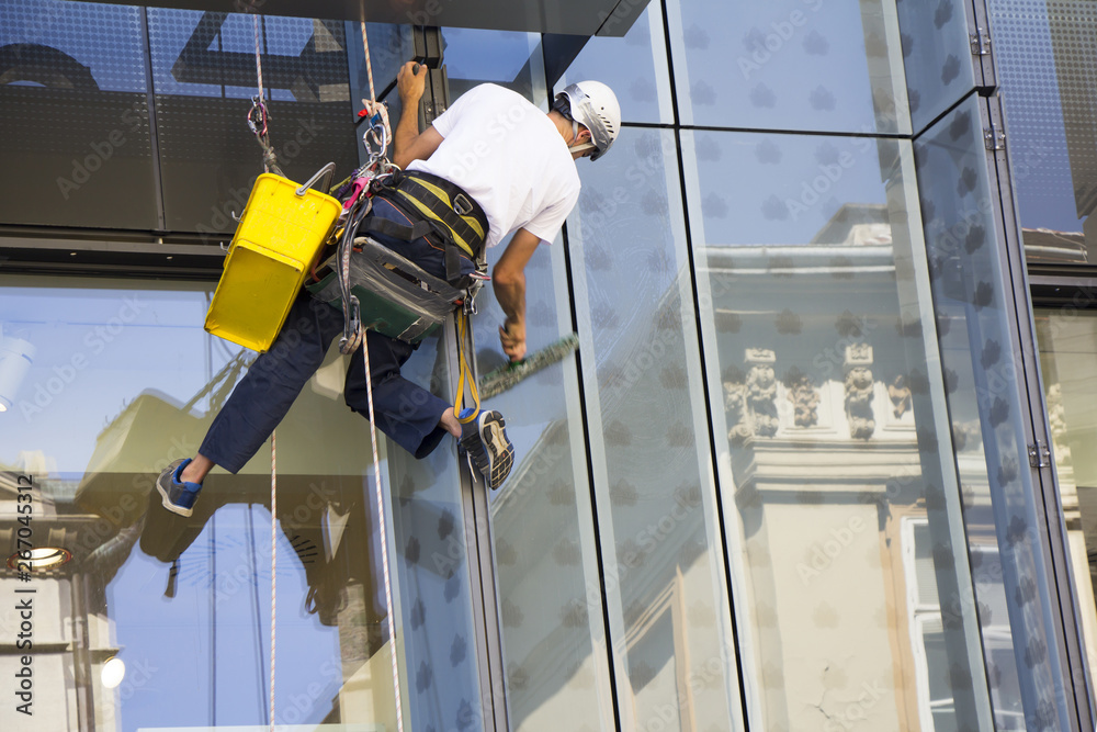 Window washer cleaning the windows of shopping center Stock Photo ...