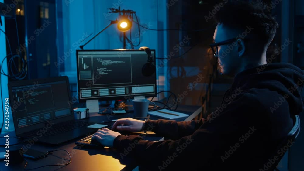 cybercrime, hacking and technology concept - asian male hacker in ...