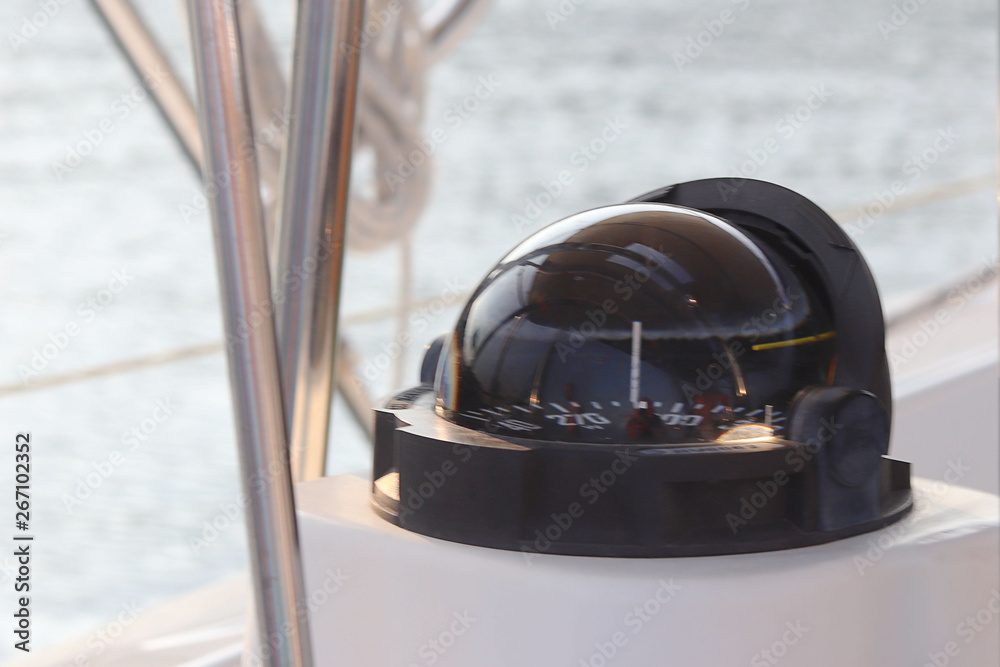 Compass in the cockpit of a sailing yacht cruise. Wind rose and ...