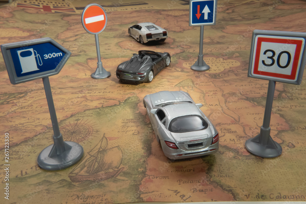 Travel concept. Toy car on vintage World map with road sign. Stock ...