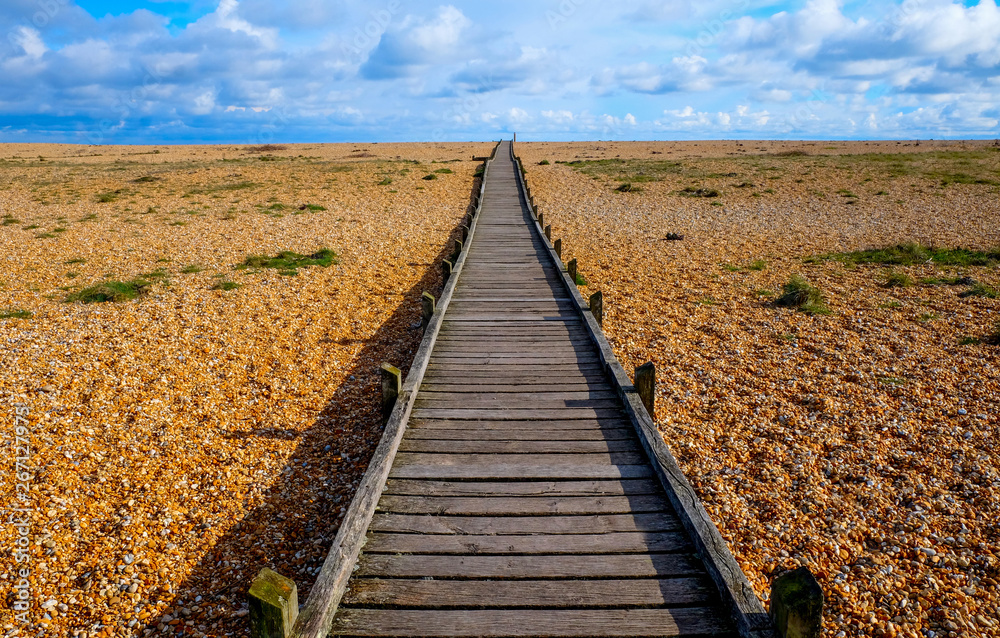 long straight wooden pathway on pebble beach Stock Photo | Adobe Stock