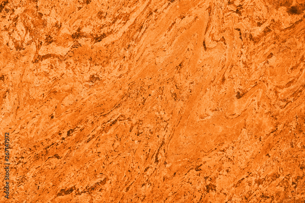 Close up of abstract turmeric orange toned granite stone texture with ...
