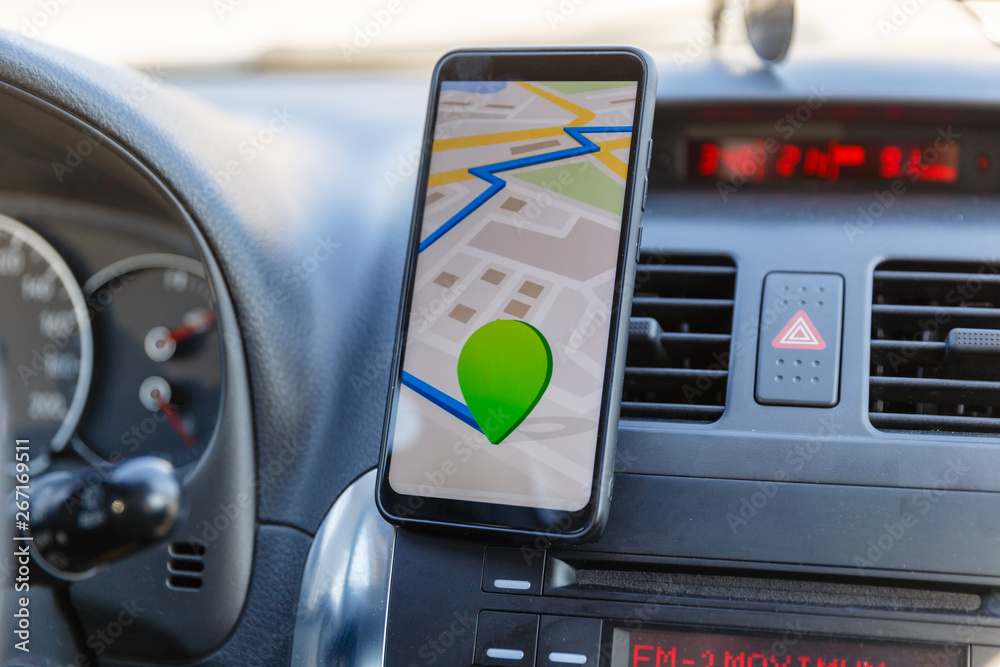 Arrival or destination point on the map in the phone on the dashboard ...