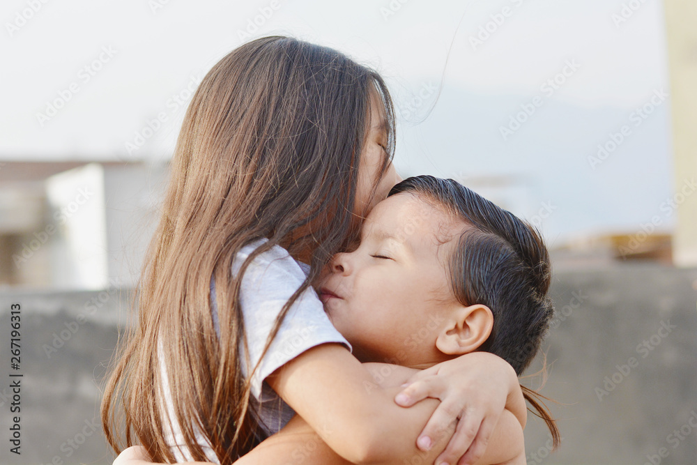 Little latin siblings hugging outside. Stock Photo | Adobe Stock