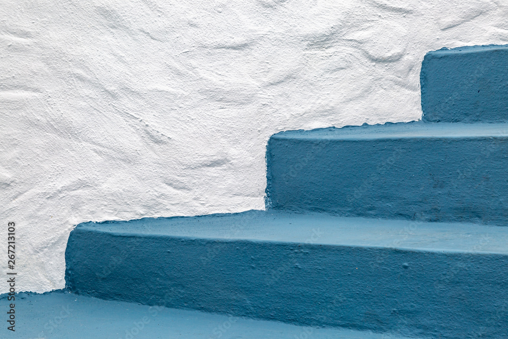 Painted blue steps and a white wall on the outside of a building Stock ...