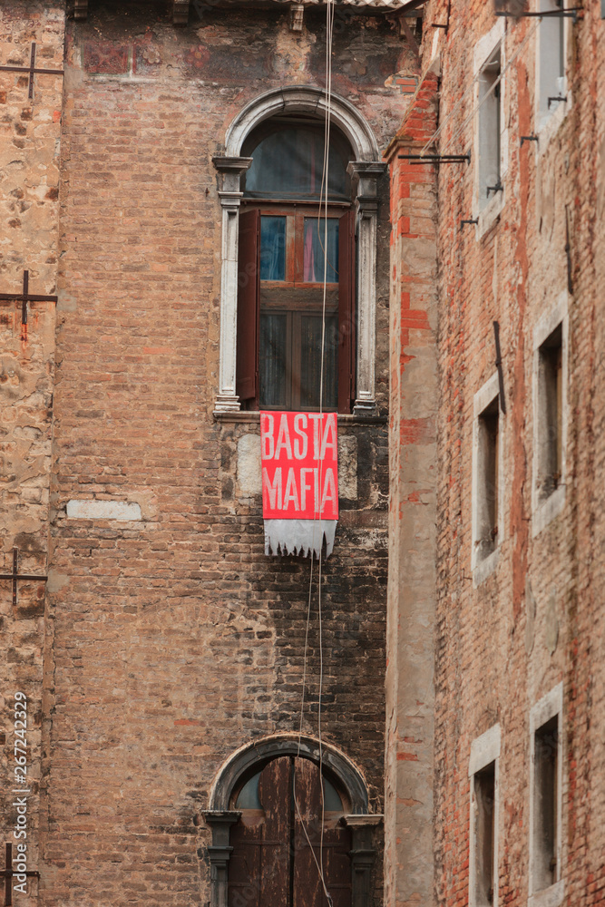 Banner reading "Basta Mafia" ("Stop Mafia") on a Brick Wall of a House ...