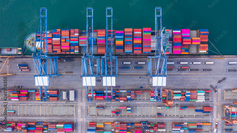 Container ship loading and unloading in deep sea port, Aerial top view ...