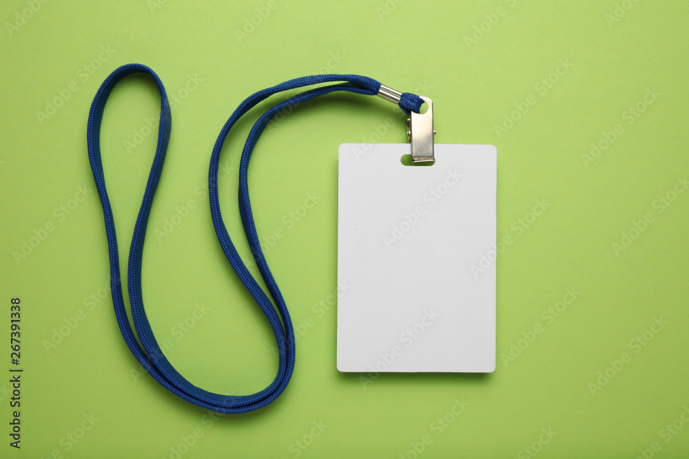 Empty name tag with white strap, mockup on green background. Stock ...