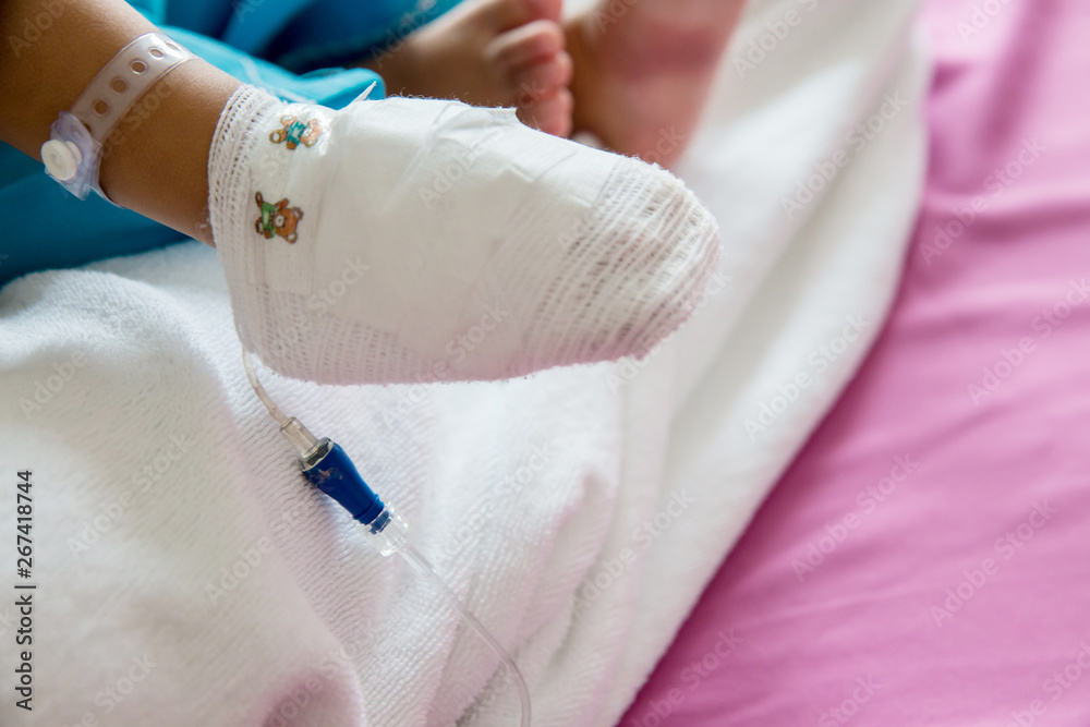 Children illness . Little Baby attaching intravenous tube to patient's ...