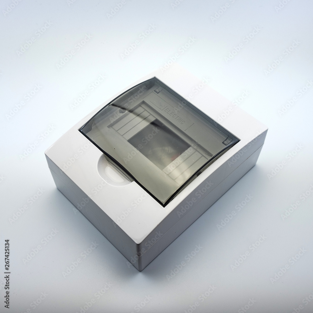 Plastic gray plastic electrical installation junction box on a white ...