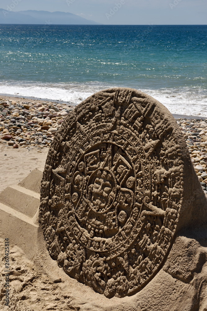 Sand sculpture of an Aztec sundial on the beach at Malecon Puerto ...