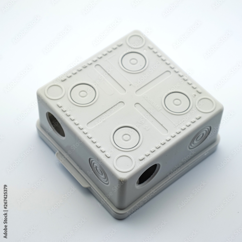 Plastic gray plastic electrical installation junction box on a white ...