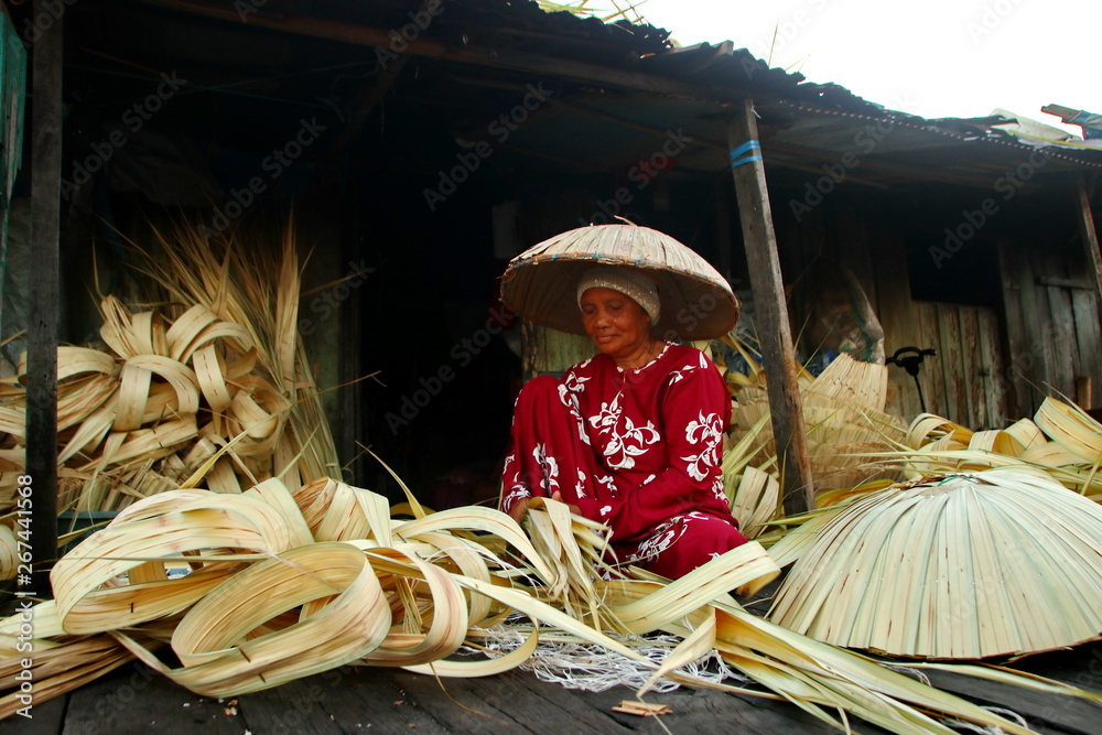 craftsmen when making Caping called Tanggui traditional Banjar hat ...