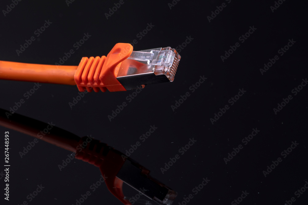 orange data cable for fast internet on black background for a modern ...