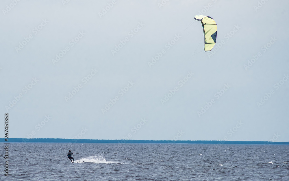 Kitesurfer far into the sea. A lot of free space in the photo. Sky Sea ...