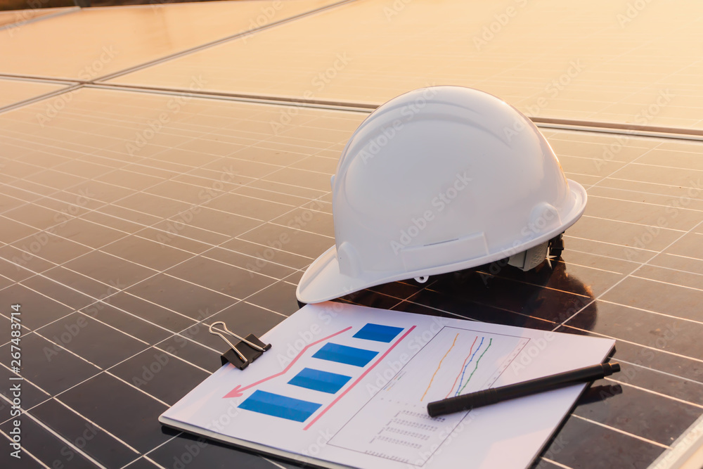 Engineers are examining the performance graph of energy production from ...