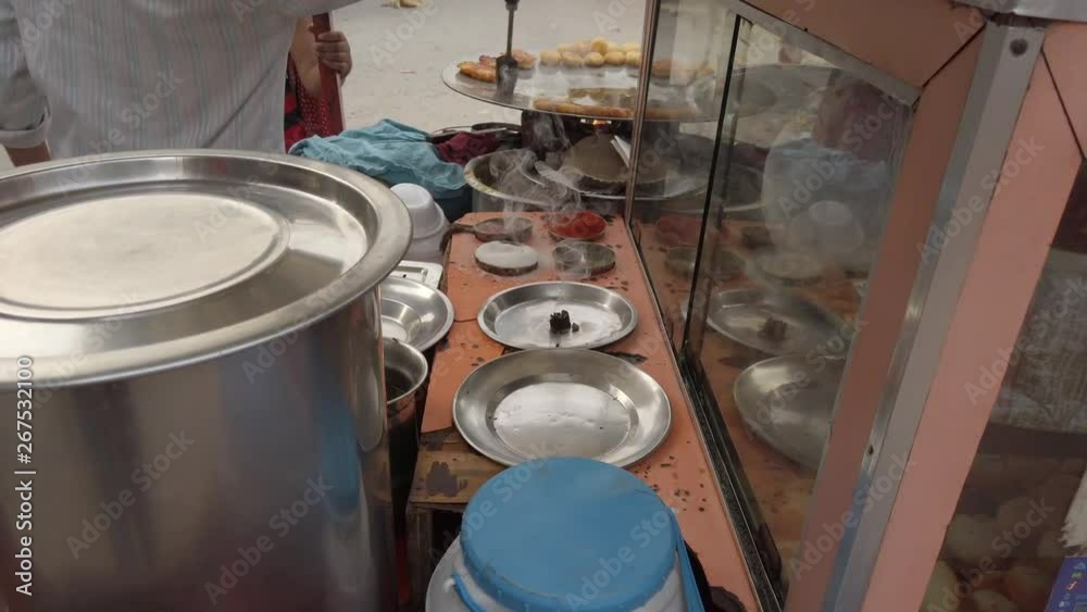 Slow-motion preparation & serving of Aloo tikki, potato cutlet, popular ...