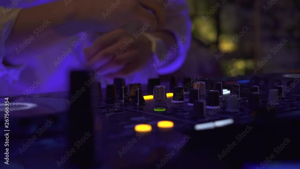 DJ hands playing music on sound console t at dance party in nightclub ...