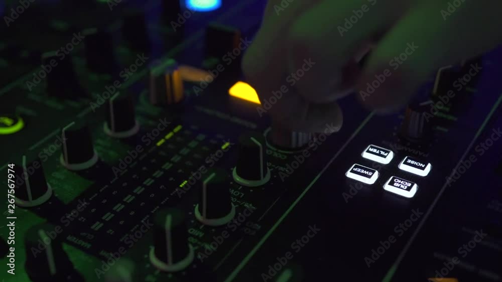 DJ controller for mixing house music and colorful light in disco club ...