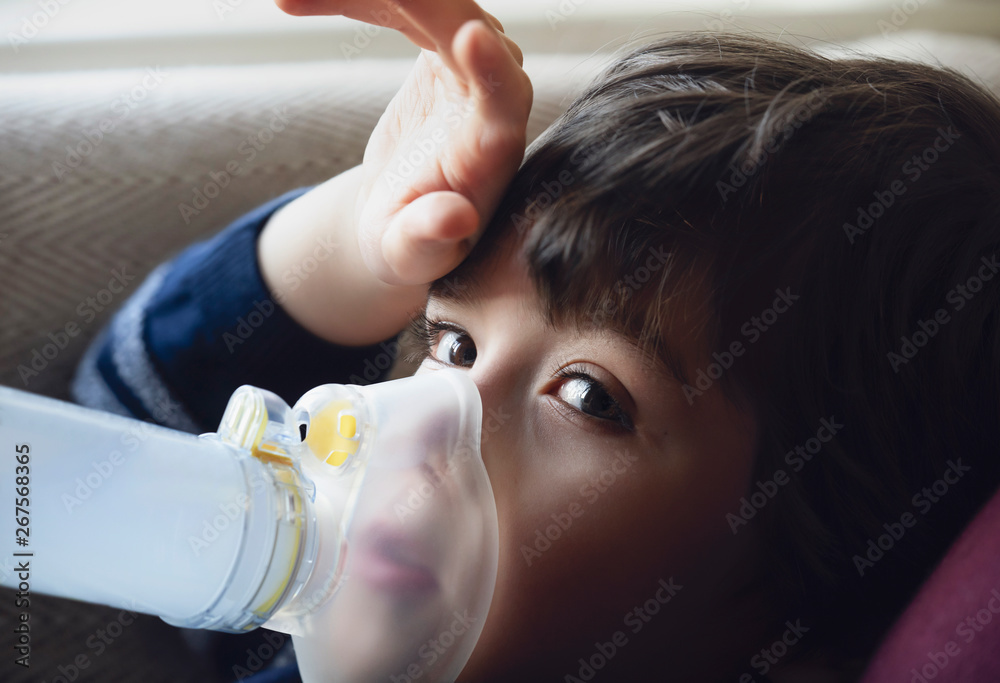 Poor boy have a problem with chest coughing holding inhaler mask, Low ...