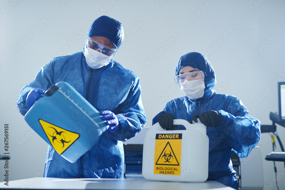 Concentrated multi-ethnic toxic laboratory colleagues in protective ...