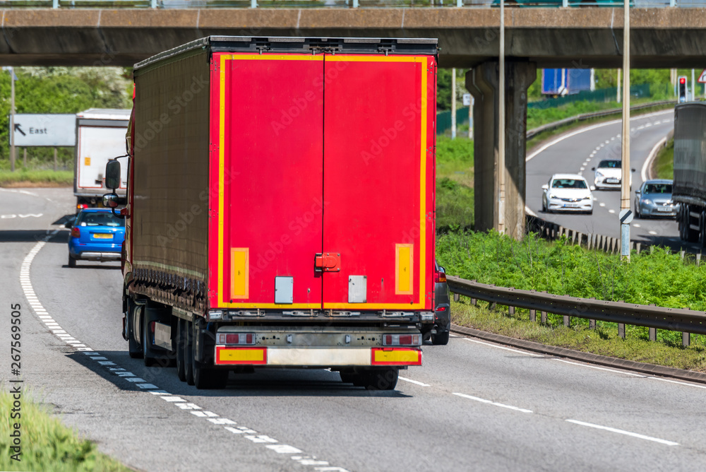 red curtain side lorry truck on uk motorway in fast motion Stock Photo ...