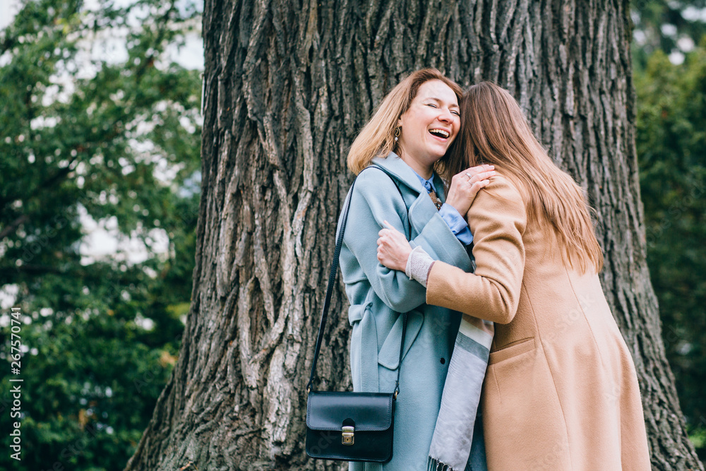 Emotional photo of two happy embracing women sisters reconciliation ...