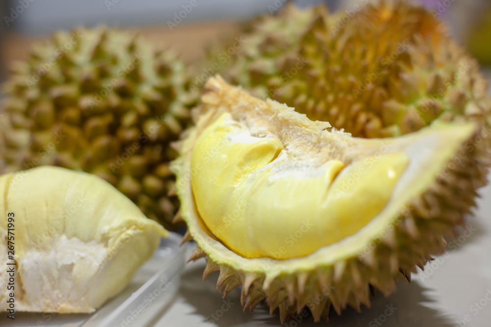 Hand peeling durian shell by knife. The durian is a king of fruit and ...