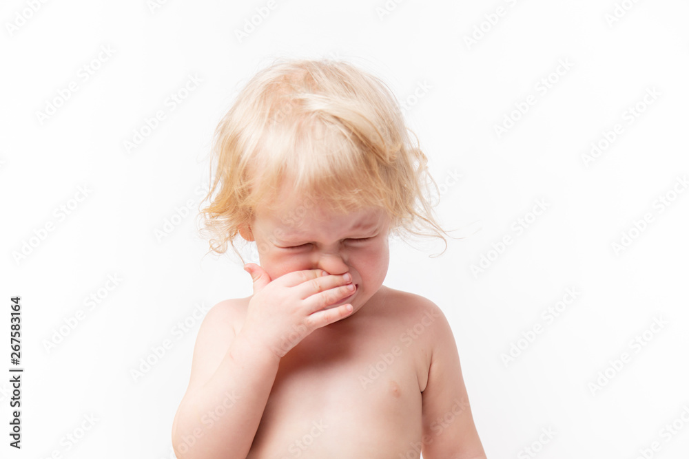 beautiful curly blond baby girl crying on a white background . child ...