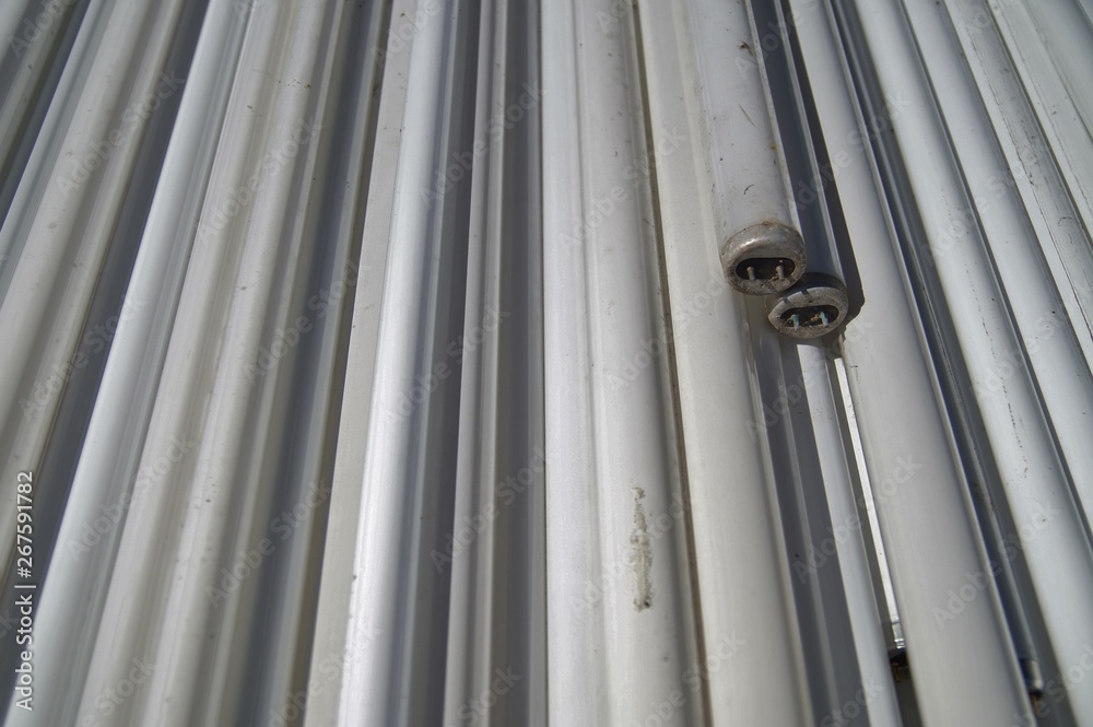 large amount of spent old fluorescent lamp tubes about to be recycled ...