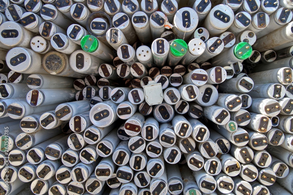 large amount of spent old fluorescent lamp tubes about to be recycled ...