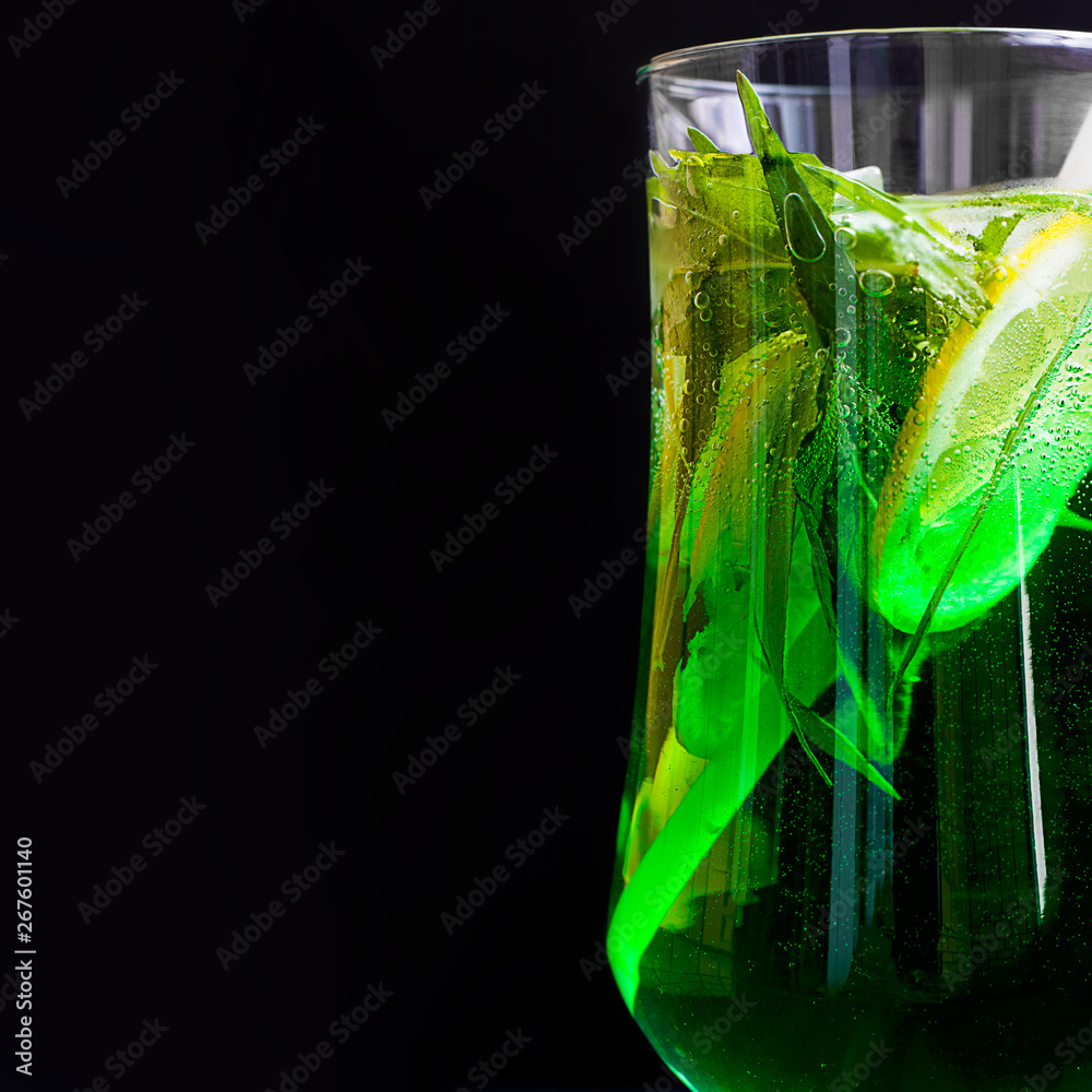 Summer cold green drink made from tarragon, with mint and slices lemon ...