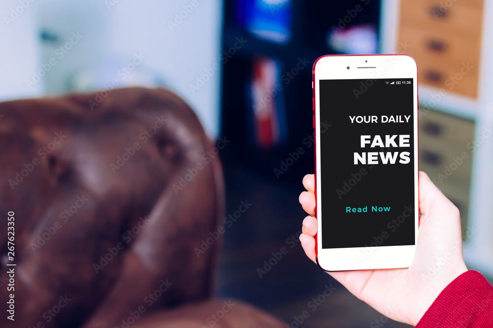 Fake news concept. Close-up view of hand holding smartphone with ...