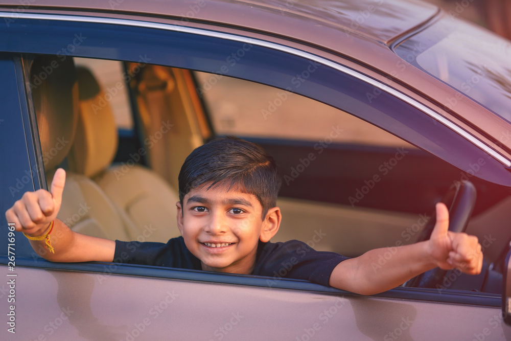 Cute Indian child in car Stock Photo | Adobe Stock