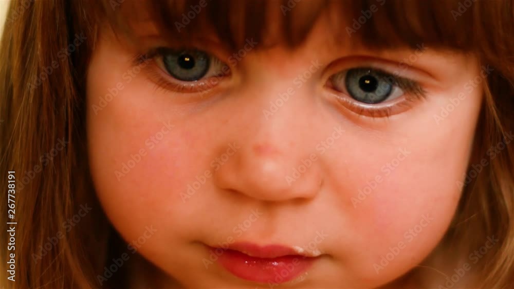 Little beautiful girl, baby infante, Caucasian. looks with his big blue ...