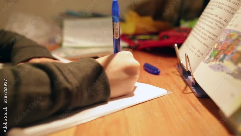 Homework Doer. closeup boy making school homework at home. boy hand ...