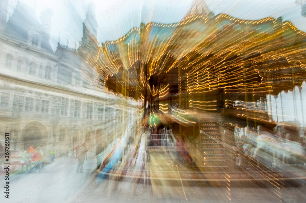 Foto de Spinning carousel in radial blur in front of Hotel de Ville in ...